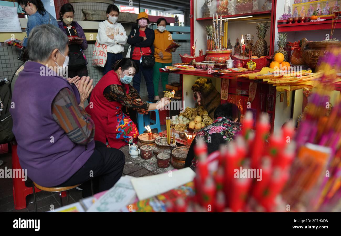 People perform a 'villain hitting' ceremony under the Canal Road ...