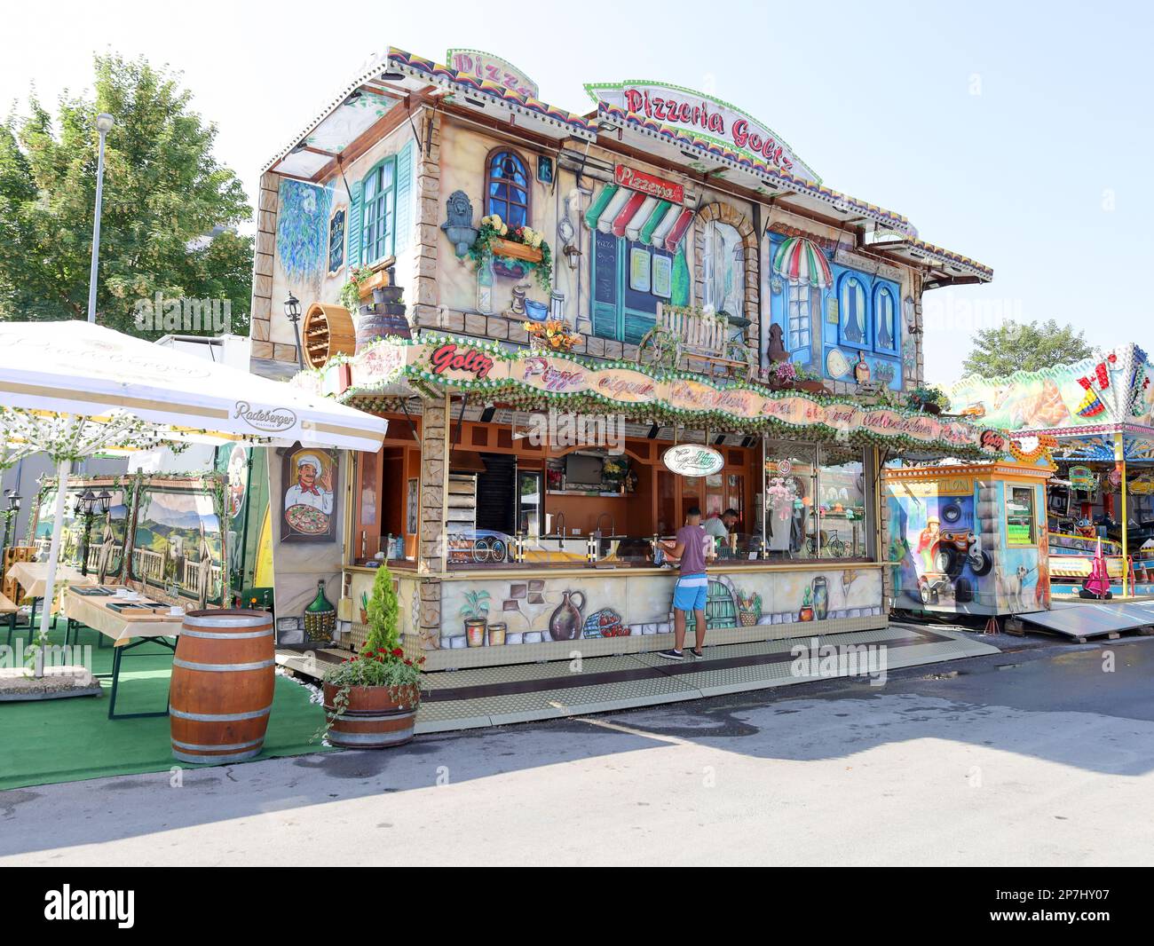 colorful booths and fun rides at a fairground Stock Photo - Alamy