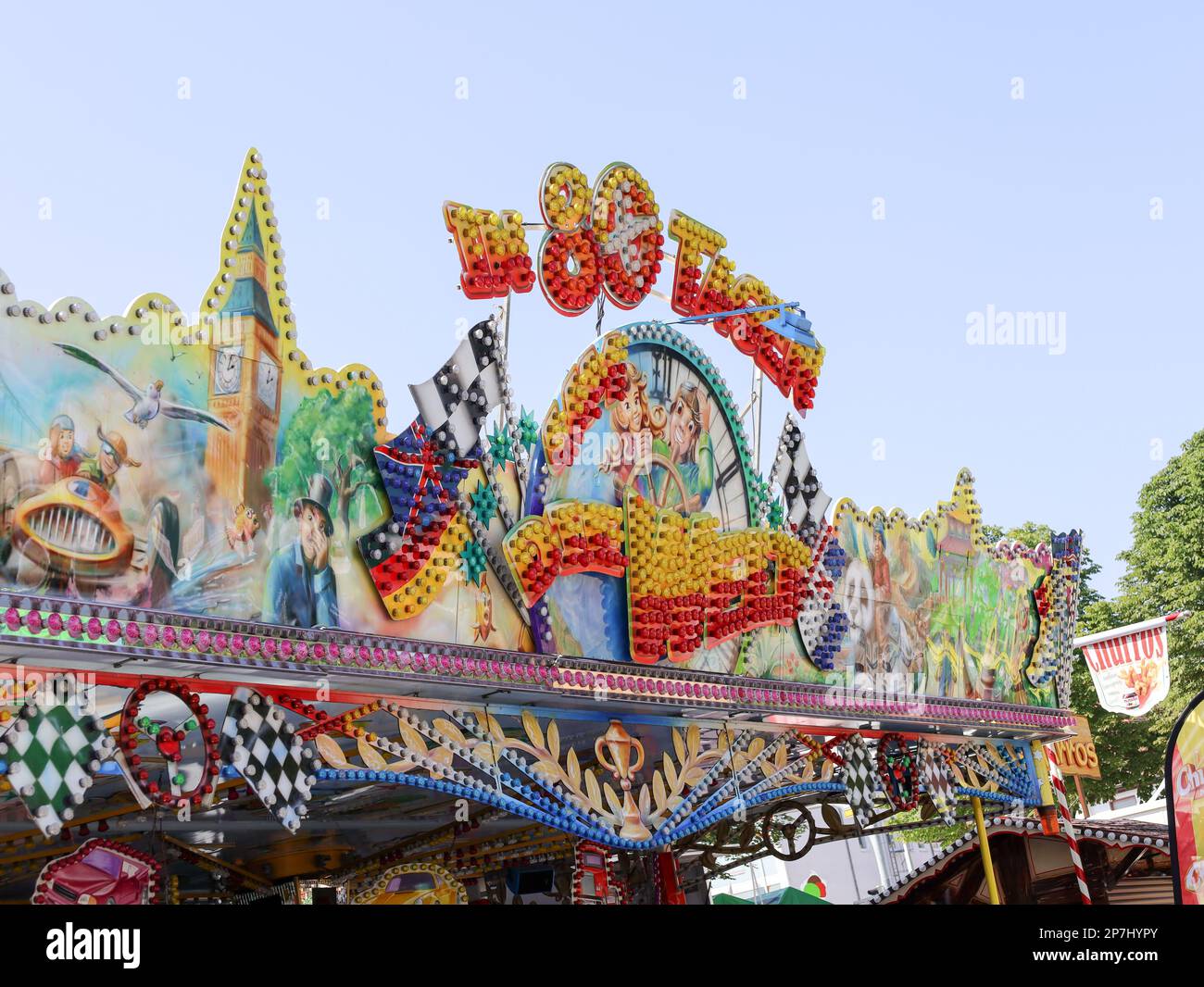 colorful booths and fun rides at a fairground Stock Photo - Alamy