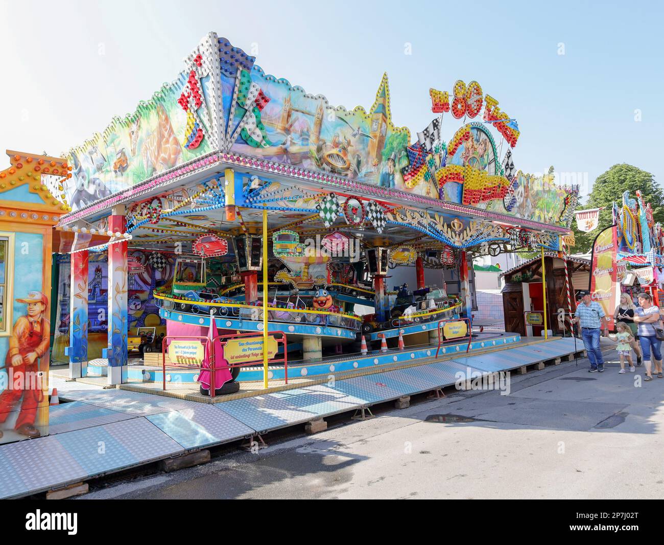 colorful booths and fun rides at a fairground Stock Photo - Alamy