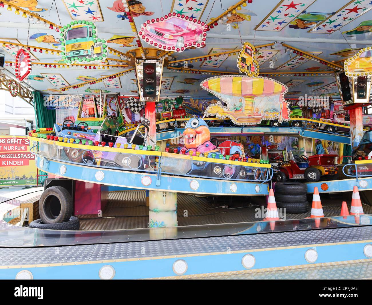 colorful booths and fun rides at a fairground Stock Photo - Alamy
