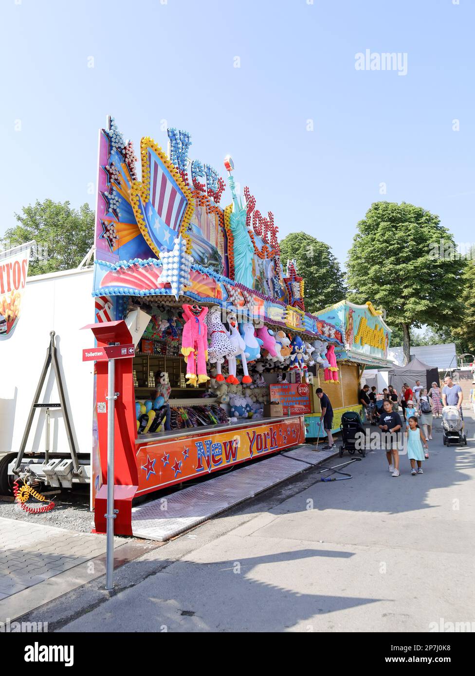 colorful booths and fun rides at a fairground Stock Photo - Alamy