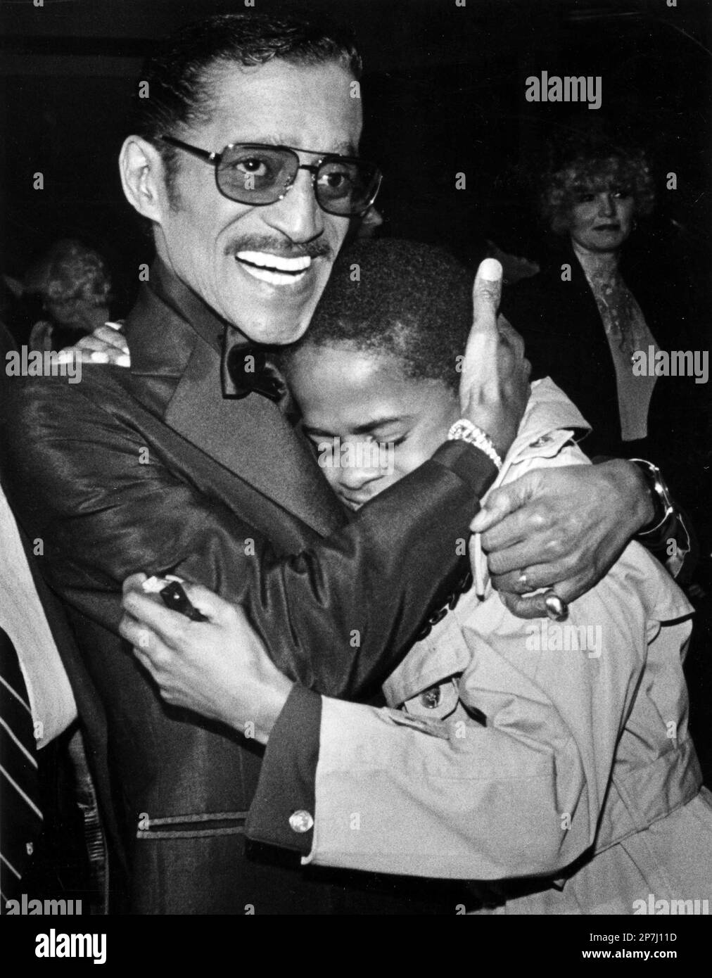 Entertainer Sammy Davis gives a hug to 11 year old Kasim Reed of ...