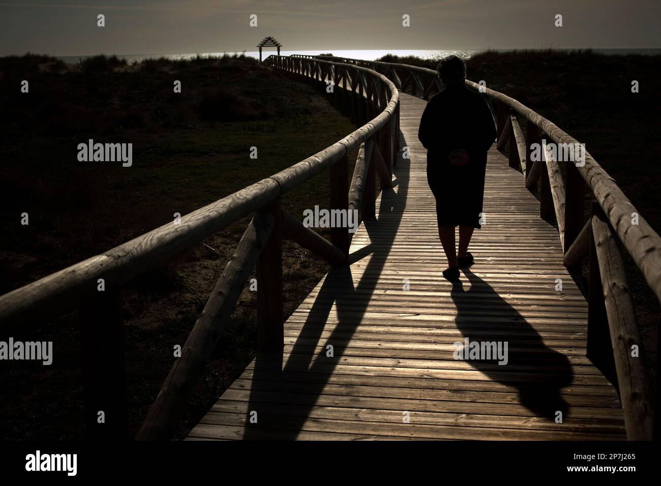 Juana, 85, walks along a wooden track during her daily walk to the ...