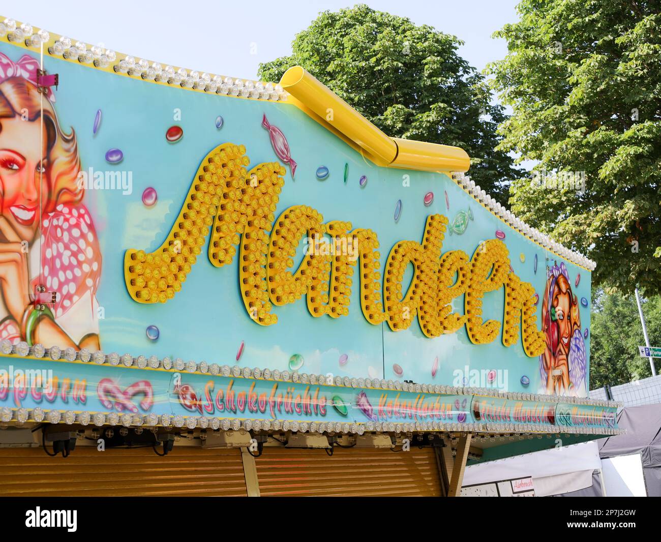 colorful booths and fun rides at a fairground Stock Photo - Alamy