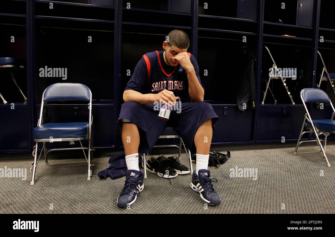 Saint Mary's Omar Samhan holds his head down in the locker room after ...
