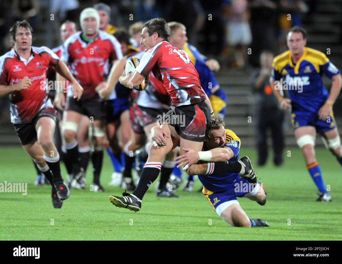 Lions' Doppies La Grange is tackled by Highlanders' Jimmy Cowan in the ...