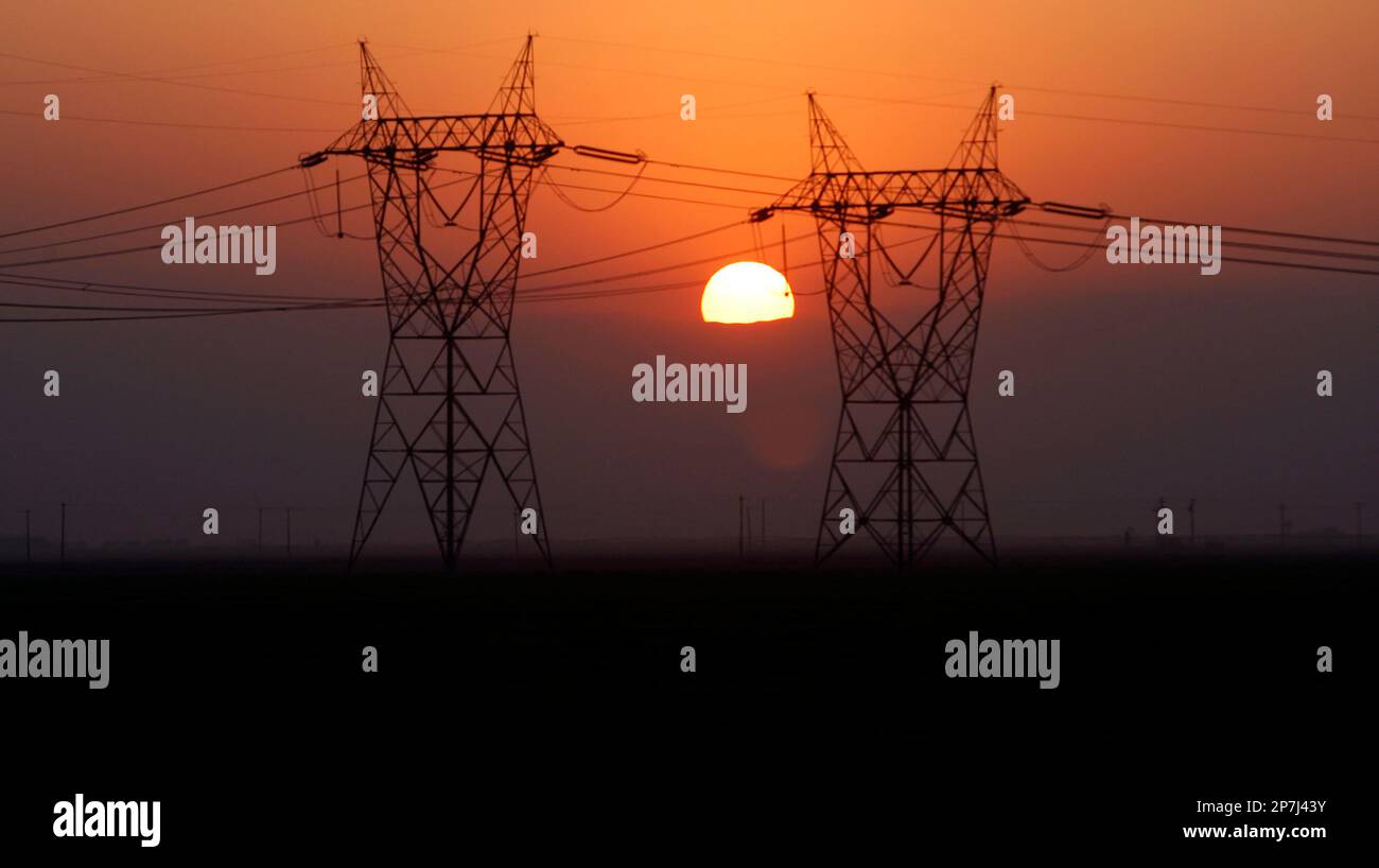 Transmission towers dot the landscape carrying power along Interstate I ...