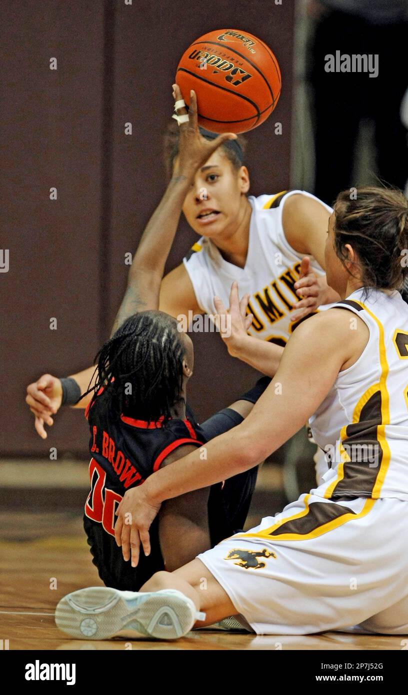 Texas Tech guard Chynna Brown manages to make a pass from the floor ...