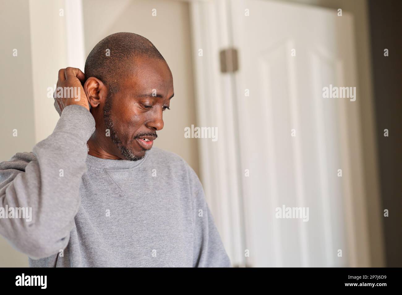 A portrait of a black man scratching his head in deep thought Stock ...