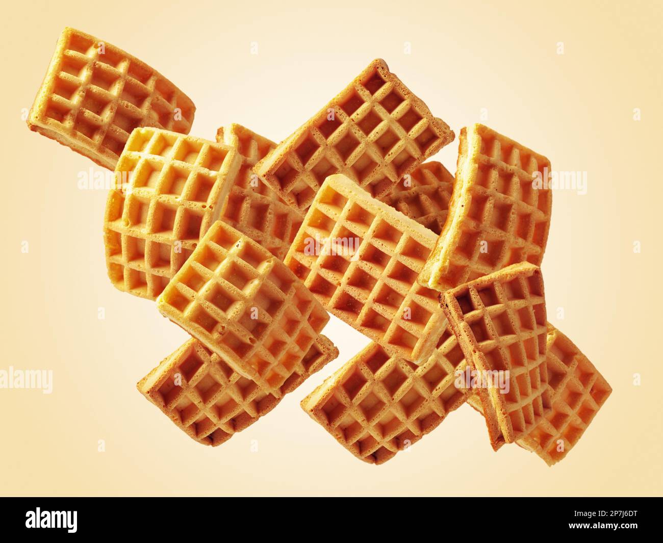 Falling Belgian waffles on a beige background Stock Photo - Alamy