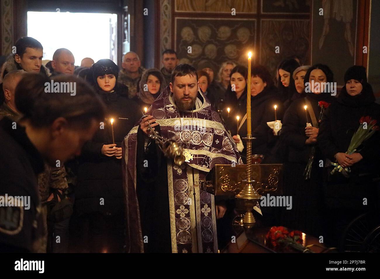 KYIV, UKRAINE - MARCH 8, 2023 - A priest conducts a memorial service ...