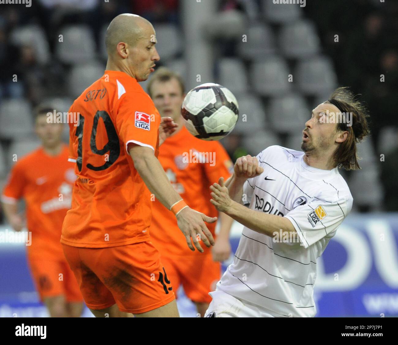 Freiburg's Jonathan Jaeger, right, challenges for the ball with Elkin ...