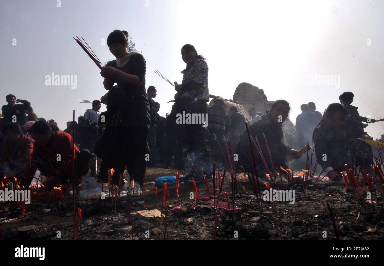 People pray for a good fortune during the traditional Mulan temple fair ...