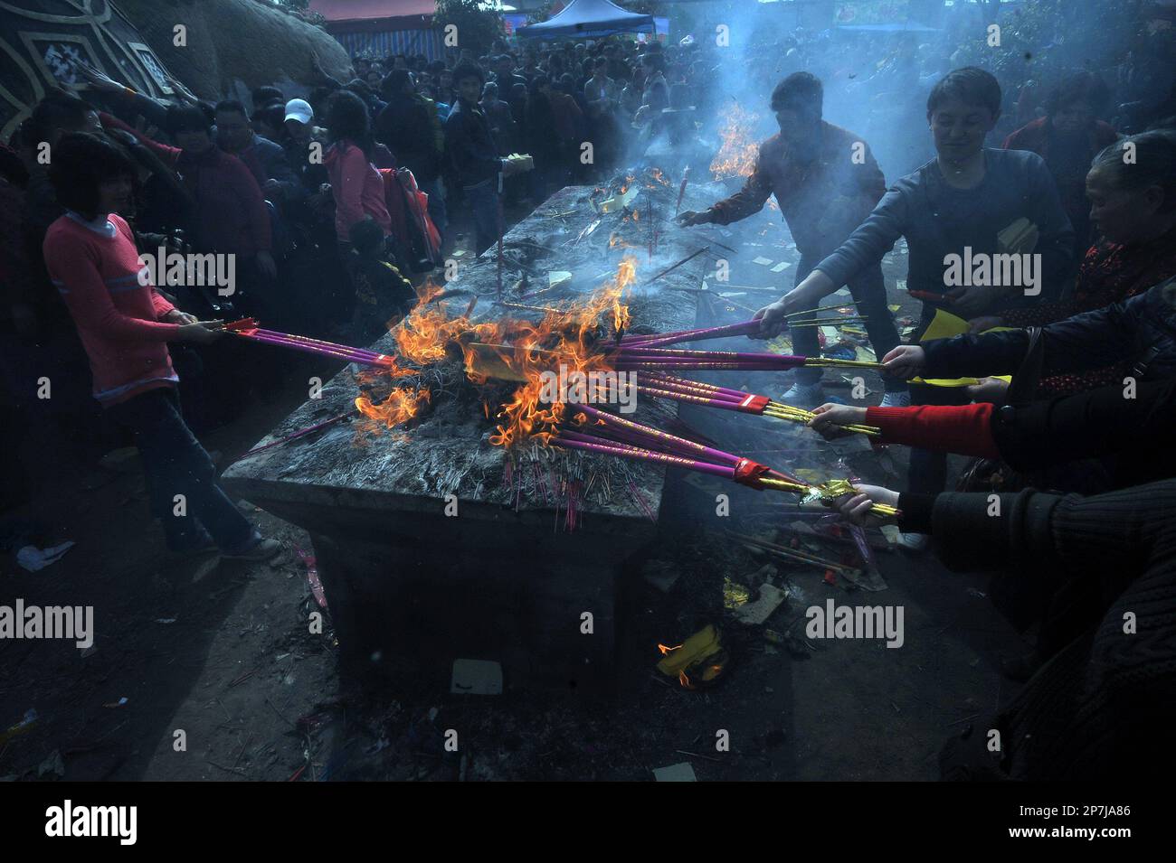 People pray for a good fortune during the traditional Mulan temple fair ...