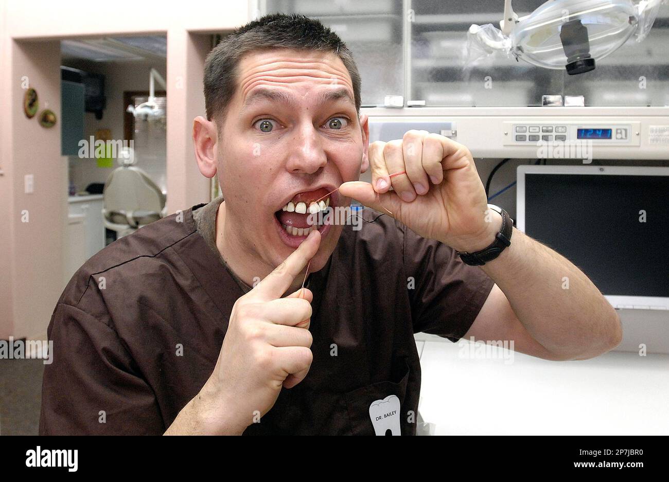 In this March 12, 2010 photo, Dentist Rich Bailey has a little fun with ...