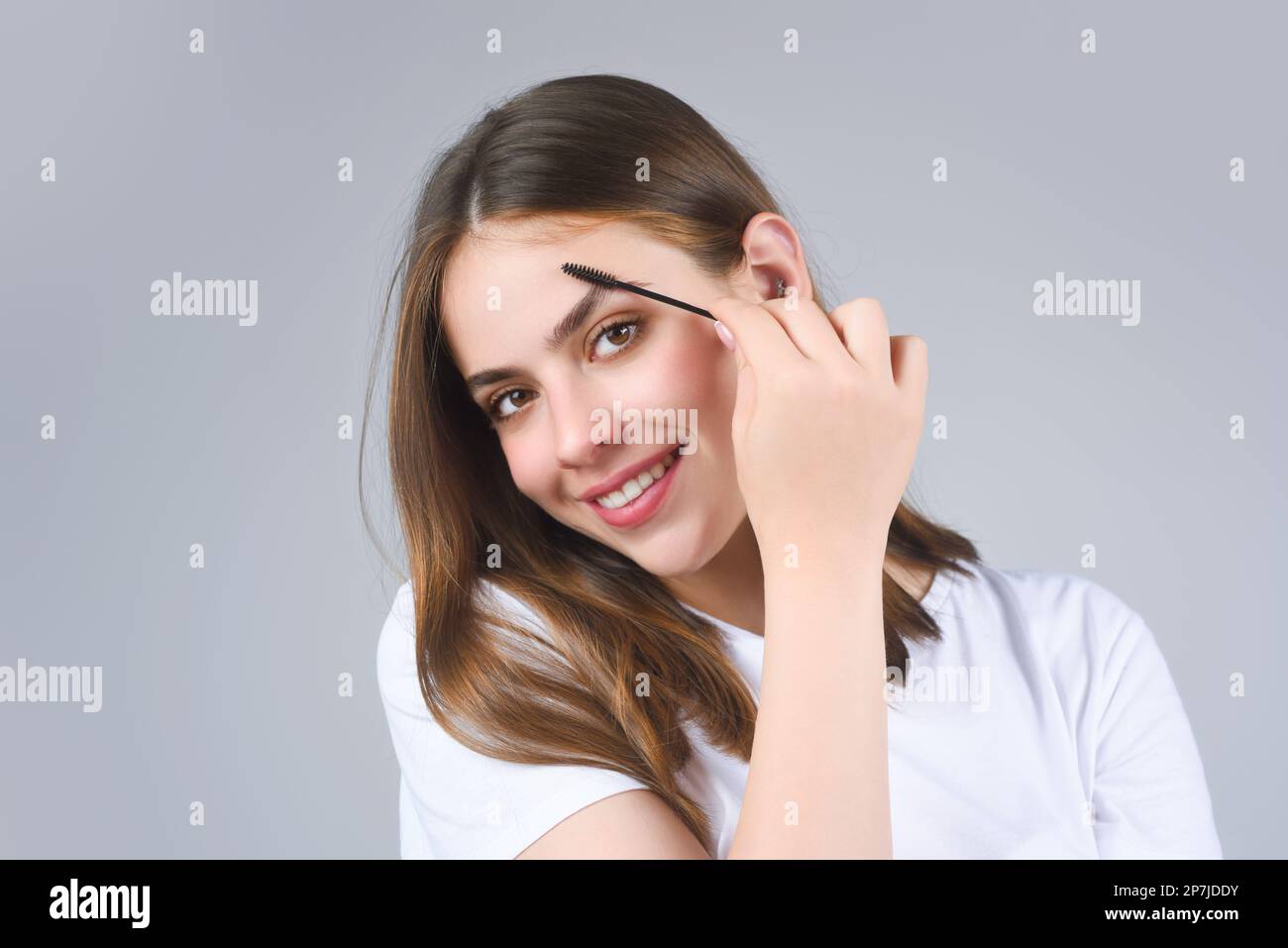 Woman shaping brown eyebrows. Woman eye with beautiful eyebrows. Shaped brows, long eyelashes ...