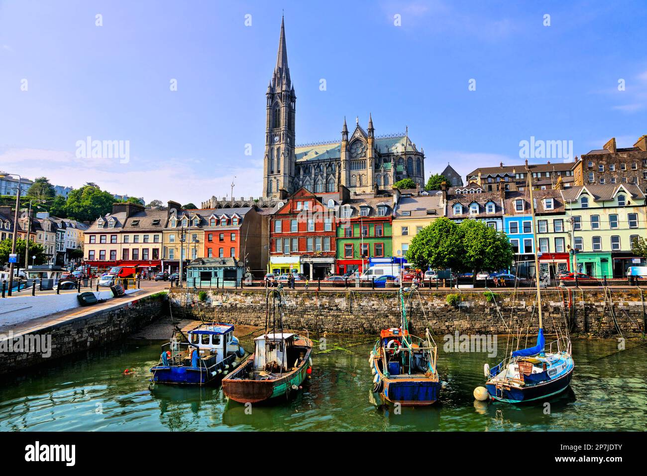 Colorful buildings and old boats with cathedral in background in the ...