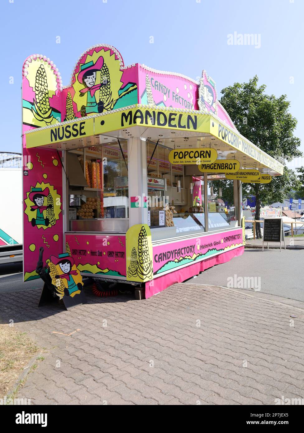 colorful booths and fun rides at a fairground Stock Photo - Alamy