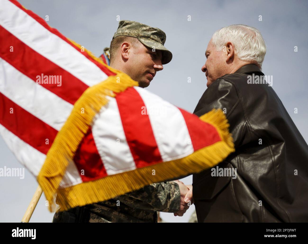 U.S. Defense Secretary Robert Gates, right, shakes hands with U.S. Army ...