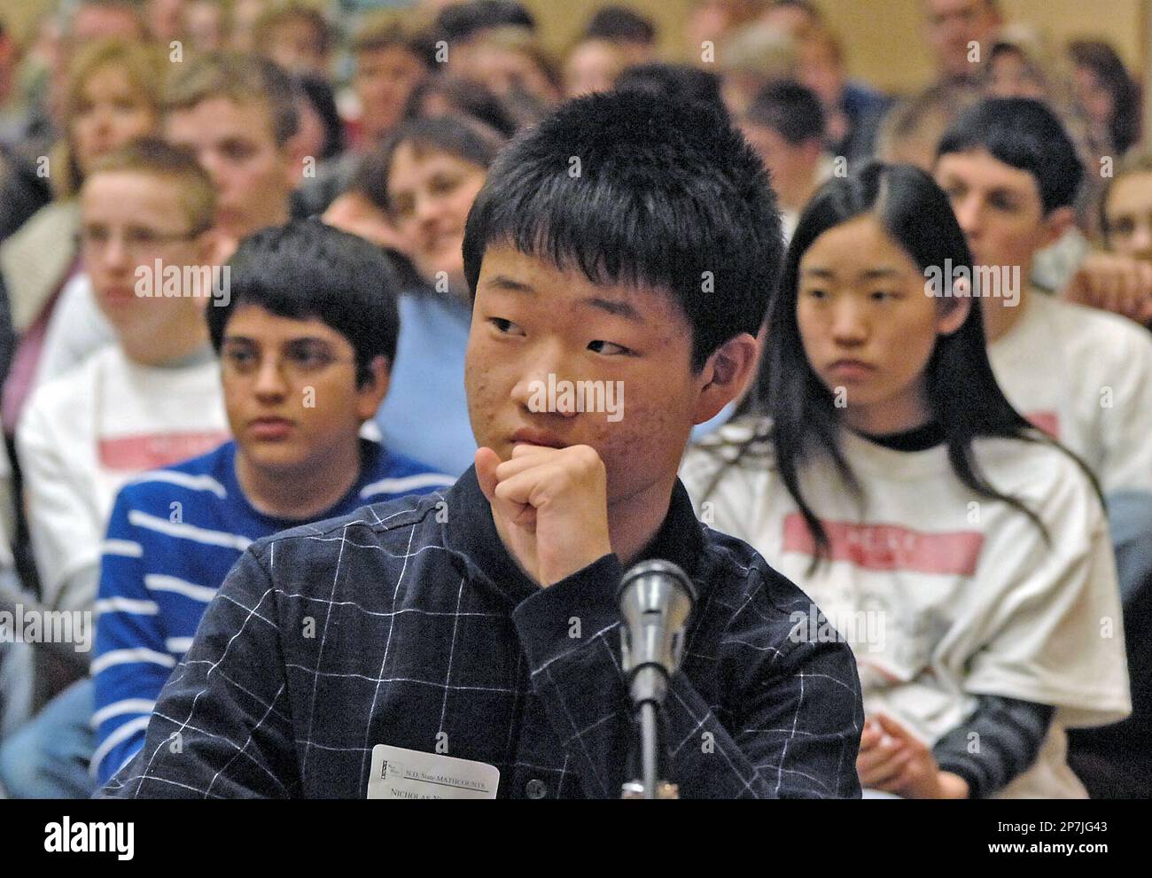 Nicholas Yugi Lui, front, ponders a math question in the final round of ...