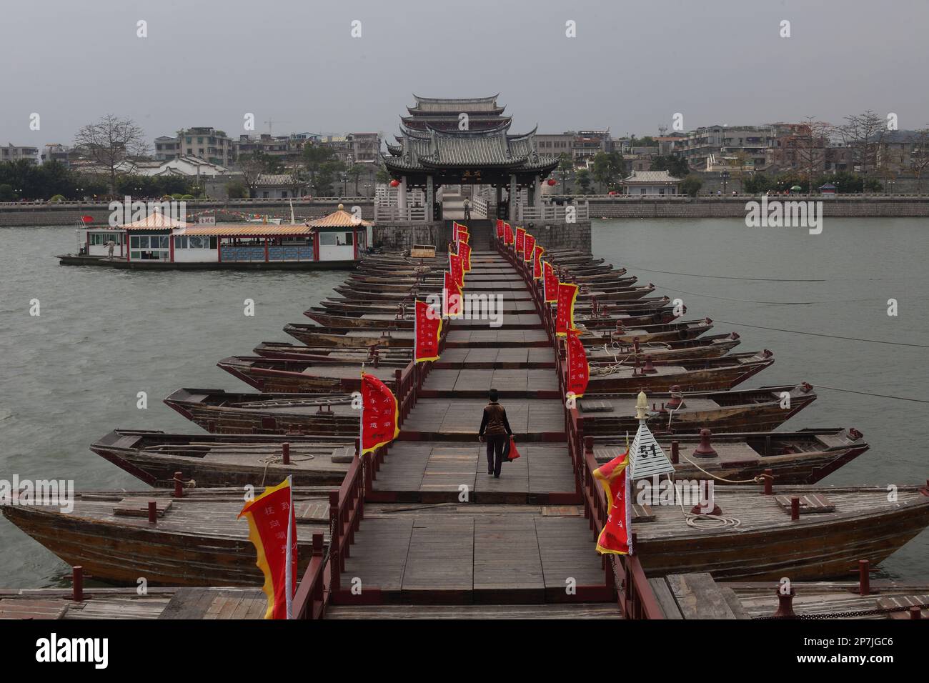 Visitors walk on the floating section of the rebuilt Guangji Bridge in ...