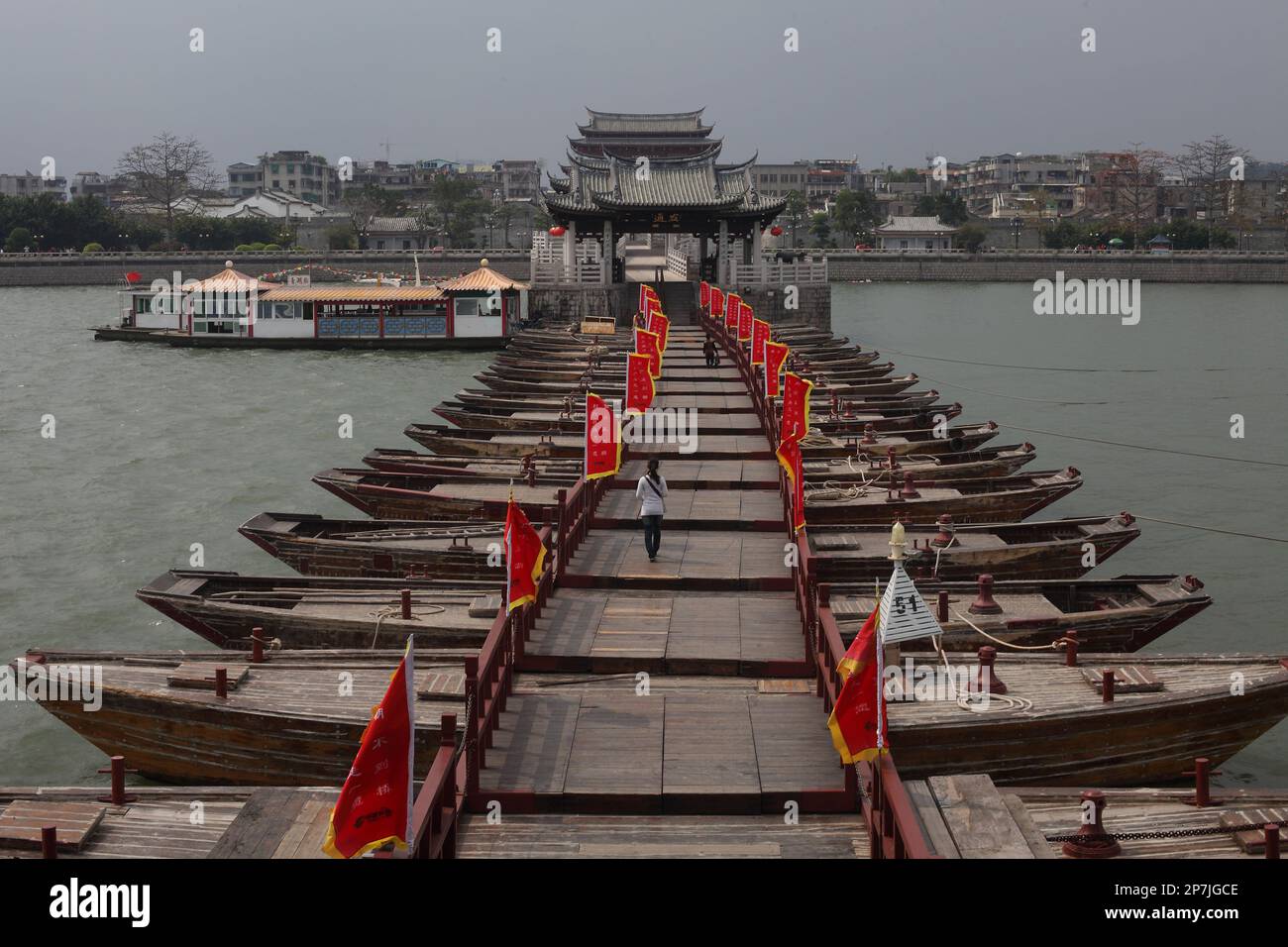 Visitors walk on the floating section of the rebuilt Guangji Bridge in ...