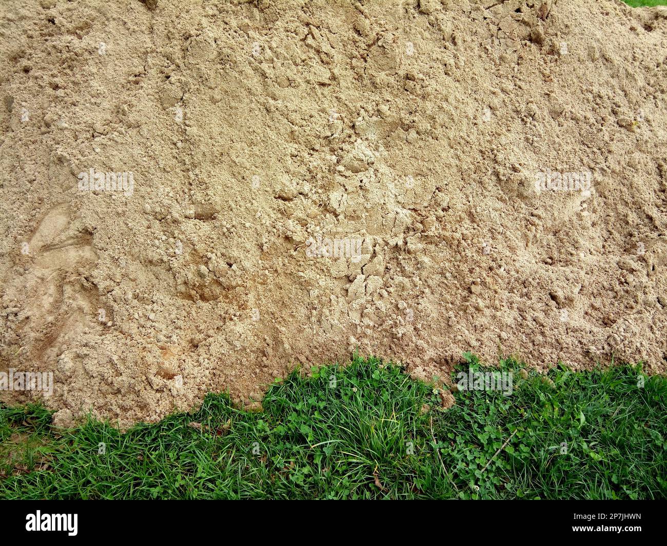 heap of sand on the green grass - industry Stock Photo - Alamy