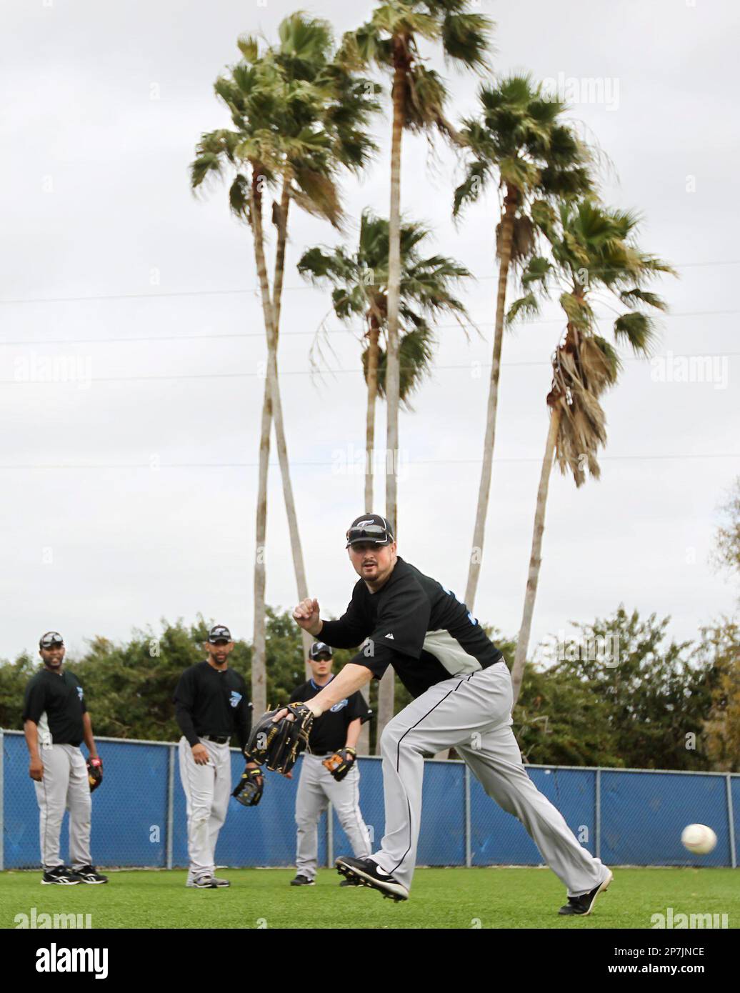 Toronto Blue Jays' Kyle Phillips, right, fields grounders with other ...