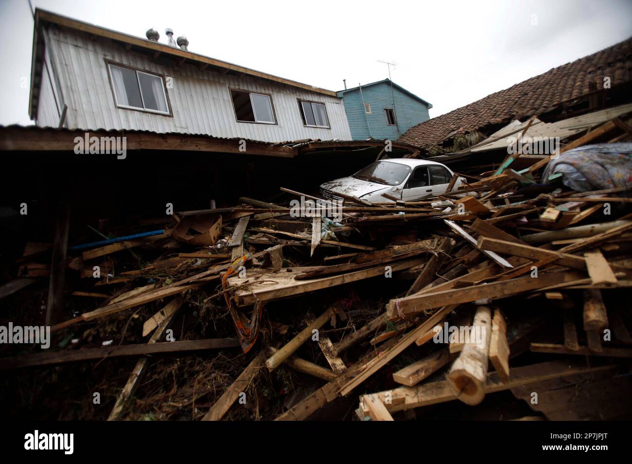 A vehicle sits on the rubble of a house after an earthquake in Curanipe ...