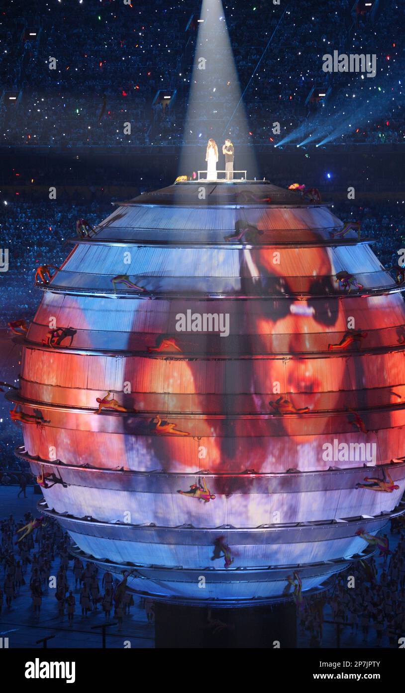 Performers walk around a floating sphere during the Opening Ceremony ...