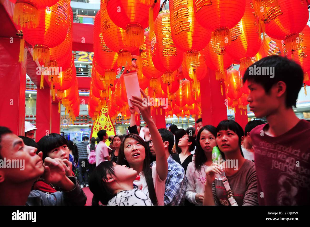 Local residents guess the riddles written on lanterns during an event ...