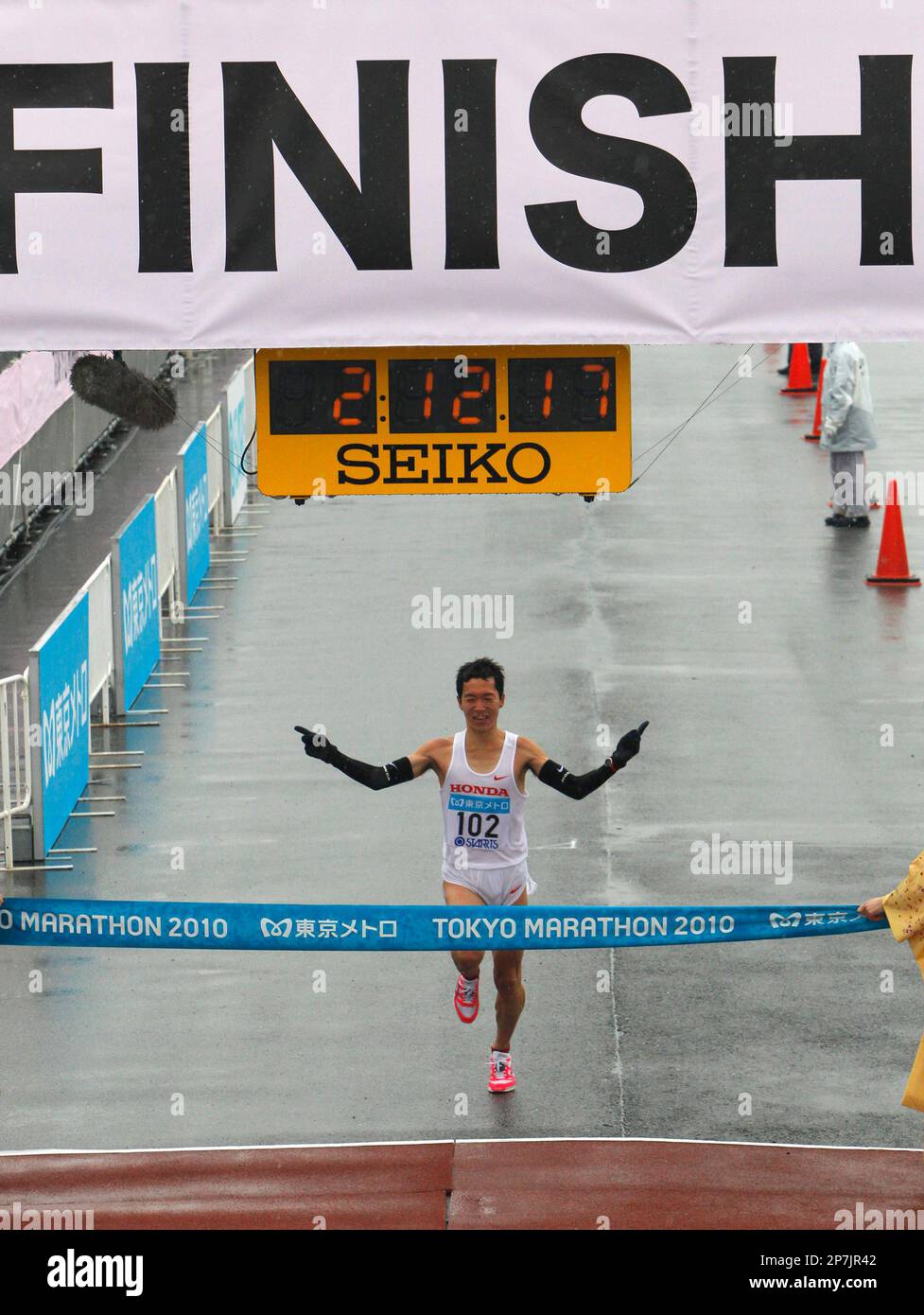 Masakazu Fujiwara of Japan crosses the finish line to win the men's ...