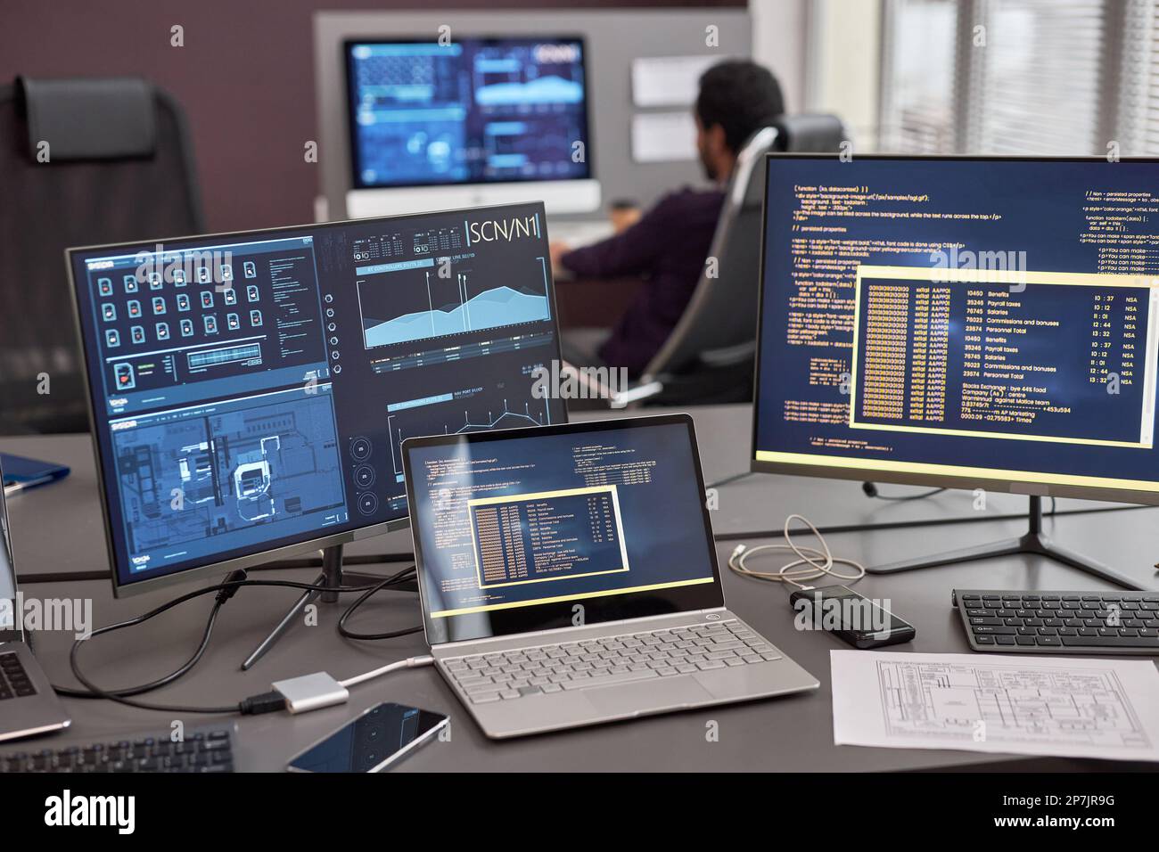 Various computer screen with code lines and data on desk in IT ...
