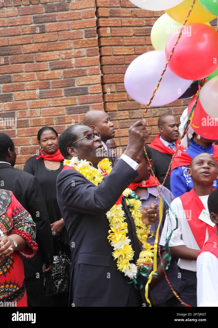 Zimbabwean President, Robert Mugabe, centre, looks up at a bunch of ...