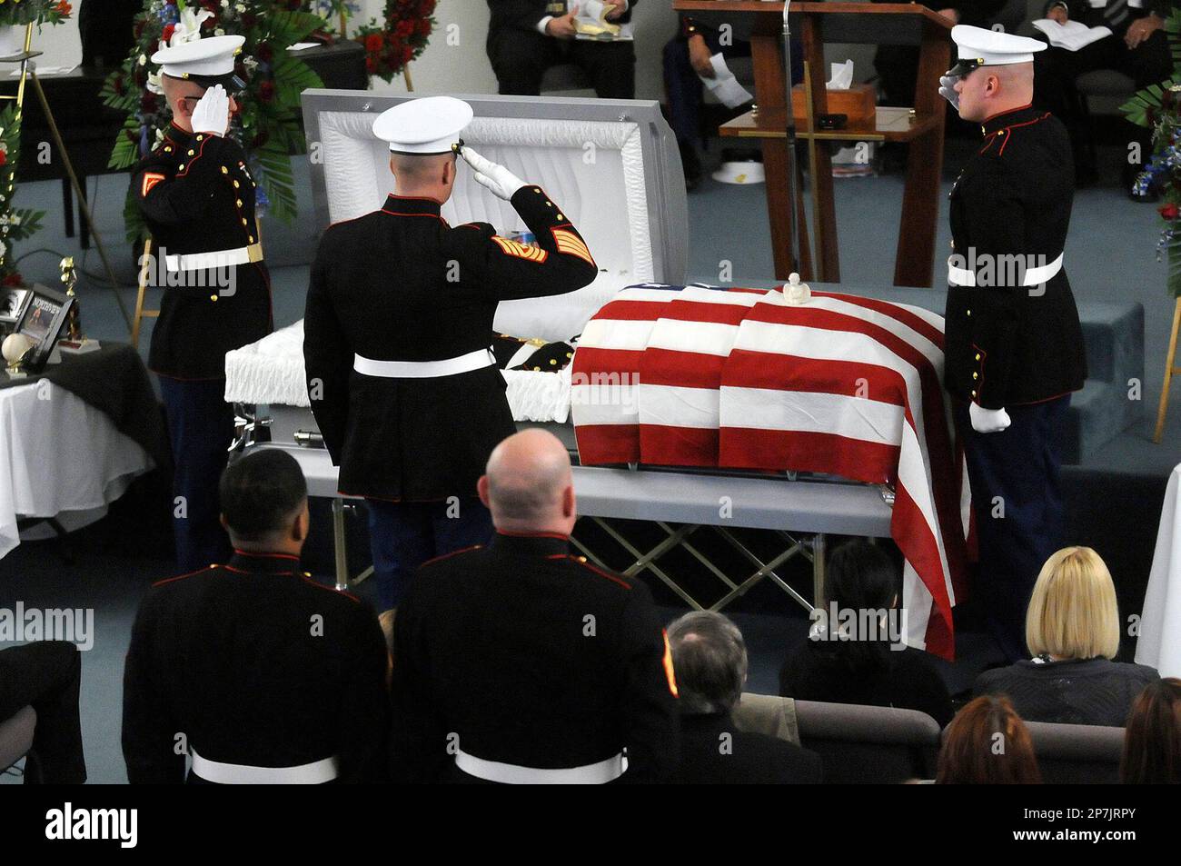 A trio of Marines salute the late Marine Cpl. Gregory Stultz before his ...