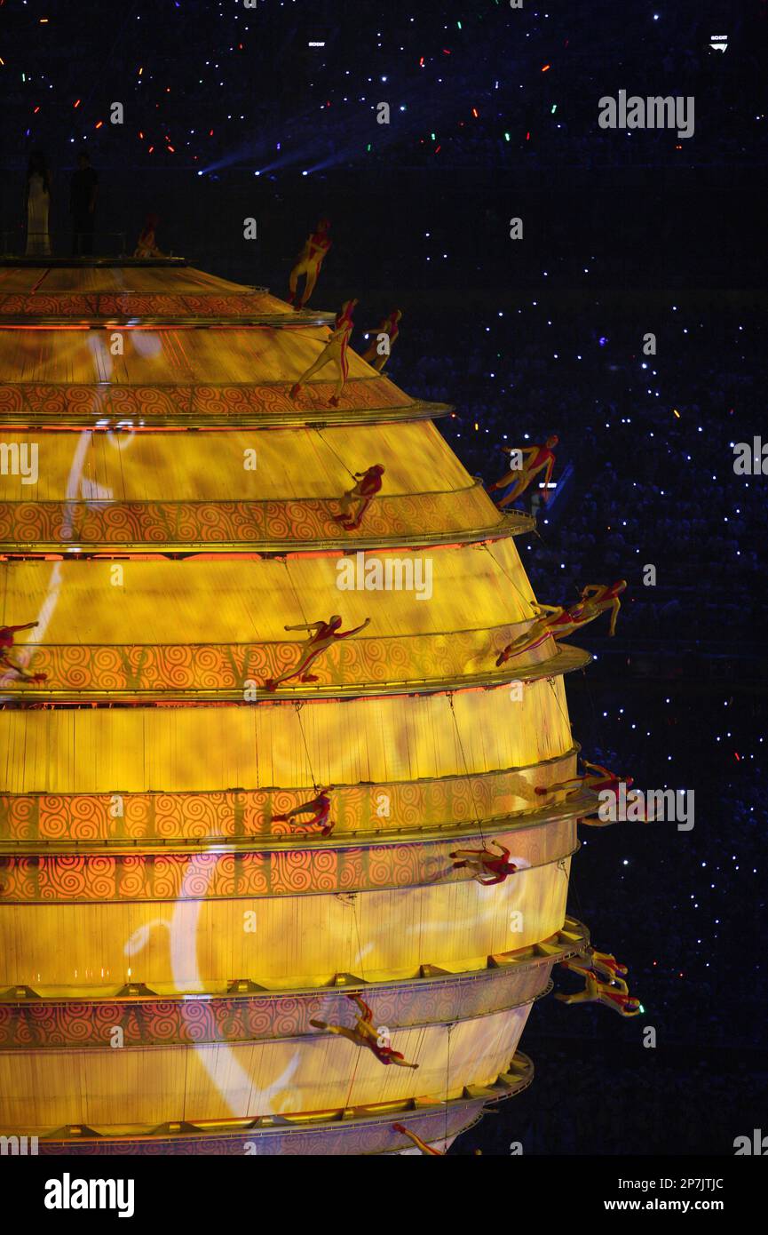 Performers walk around a floating sphere during the Opening Ceremony ...
