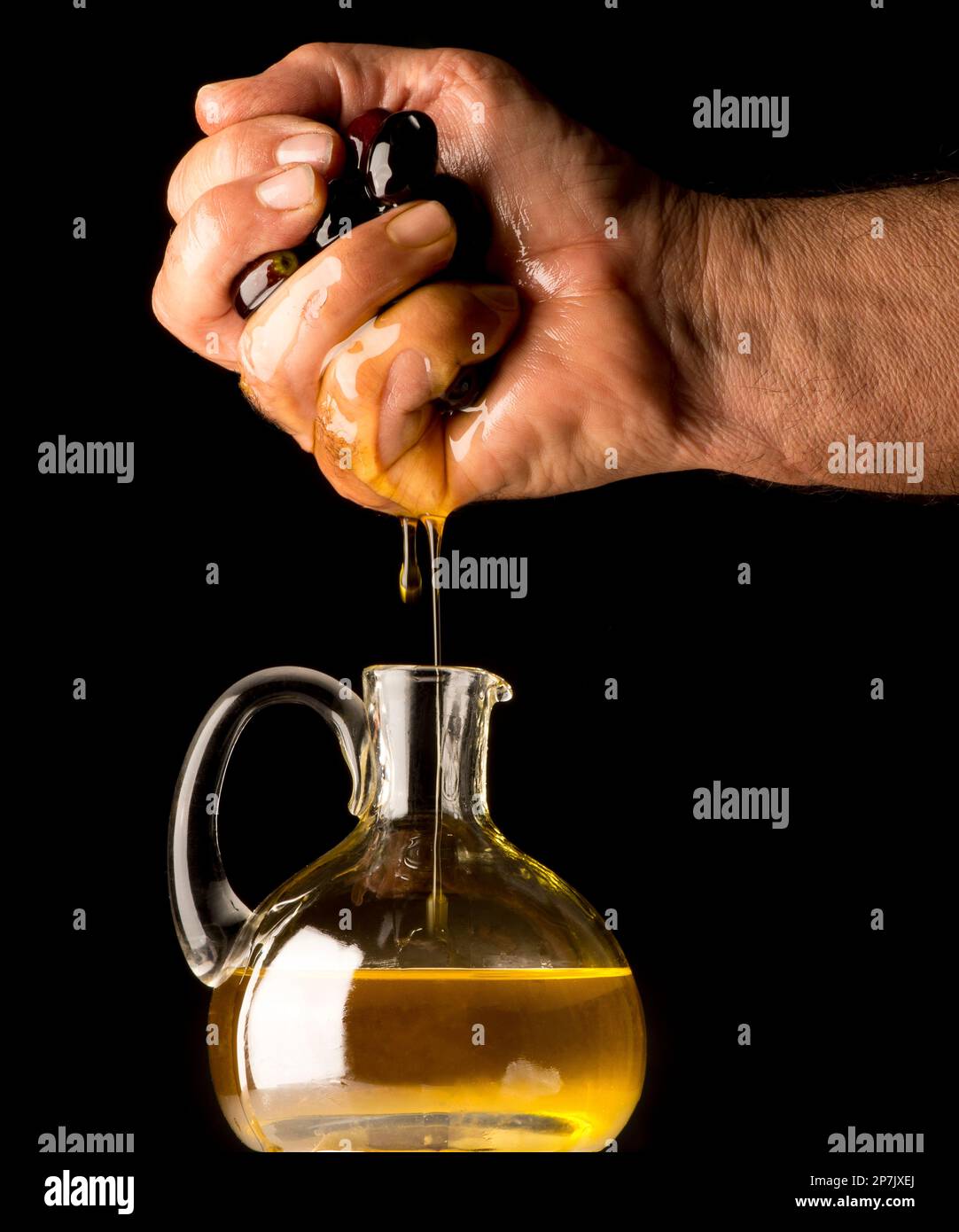 hand is squeezing olive oil Stock Photo - Alamy