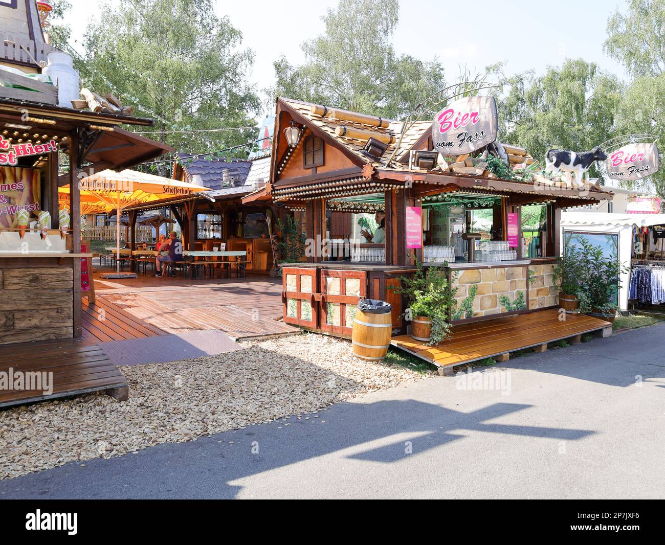 colorful booths and fun rides at a fairground Stock Photo - Alamy