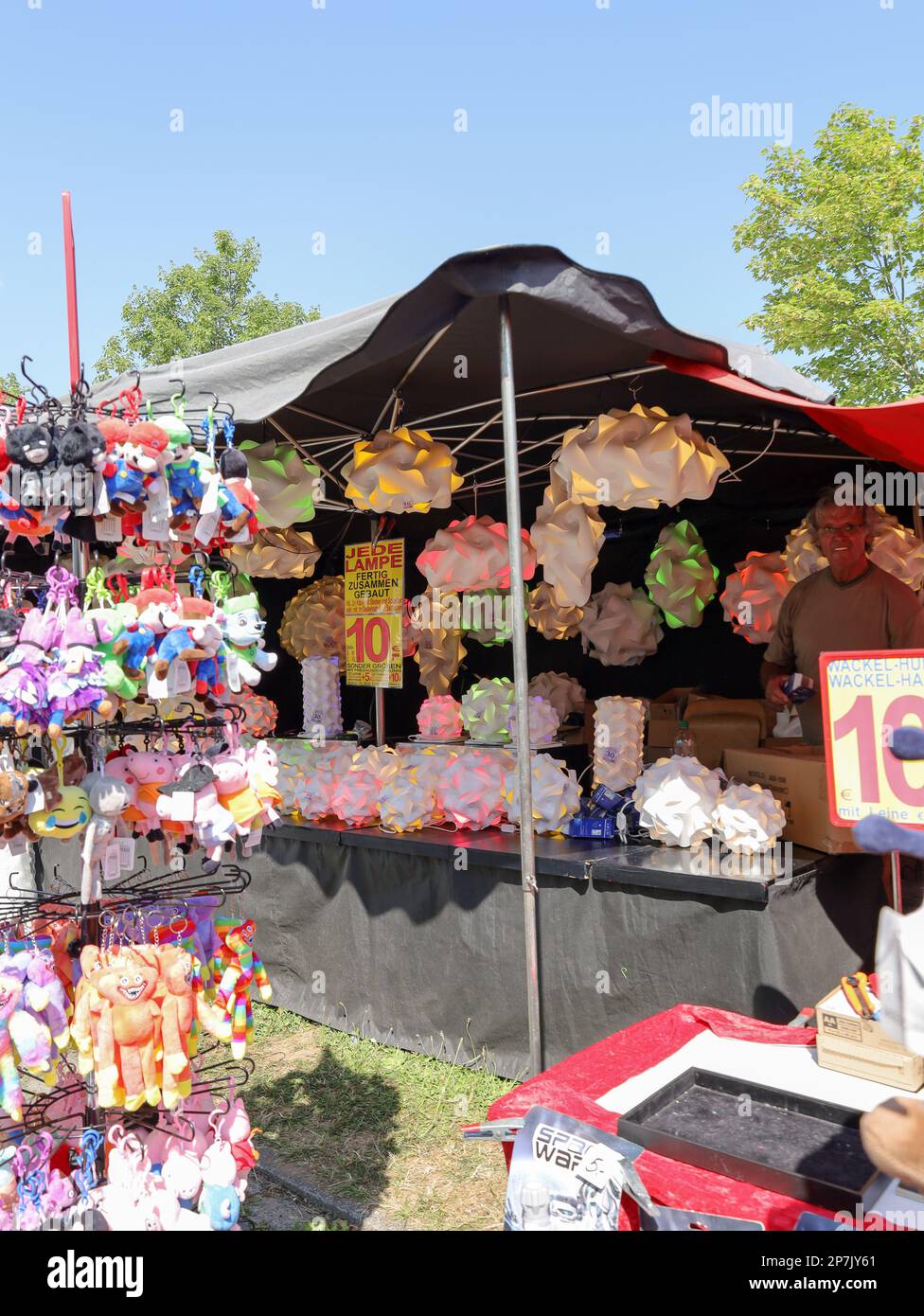 colorful booths and fun rides at a fairground Stock Photo - Alamy