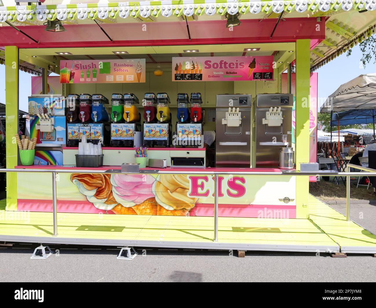 colorful booths and fun rides at a fairground Stock Photo - Alamy