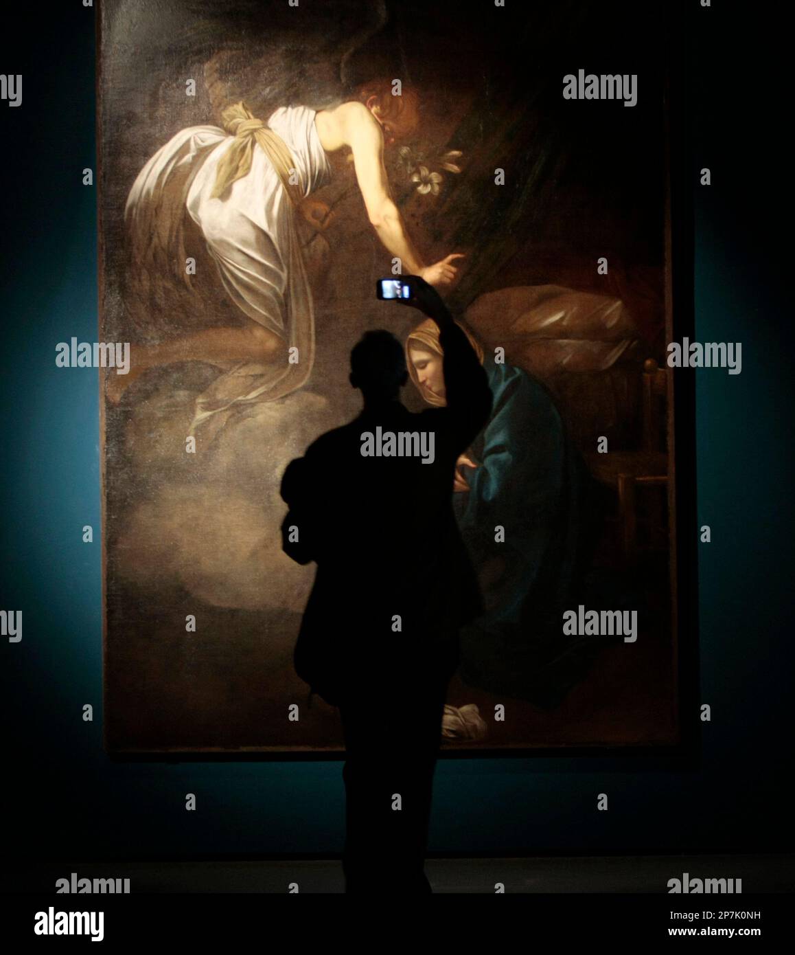 A man takes a picture of Caravaggio's "Annunciation" during the ...