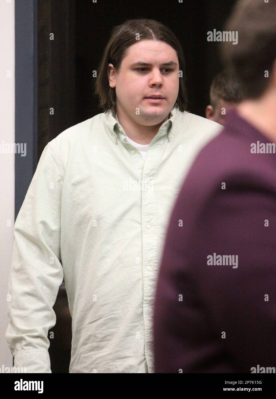 Mark Becker walks back into the courtroom after a short break in his ...