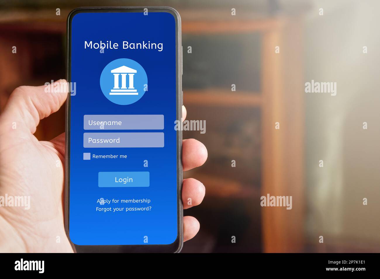 Male hand holding mobile phone with online banking app interface on the ...