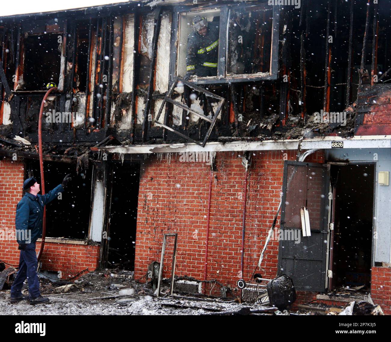 The Flint Fire Department works to put out a flare up at a fire that ...
