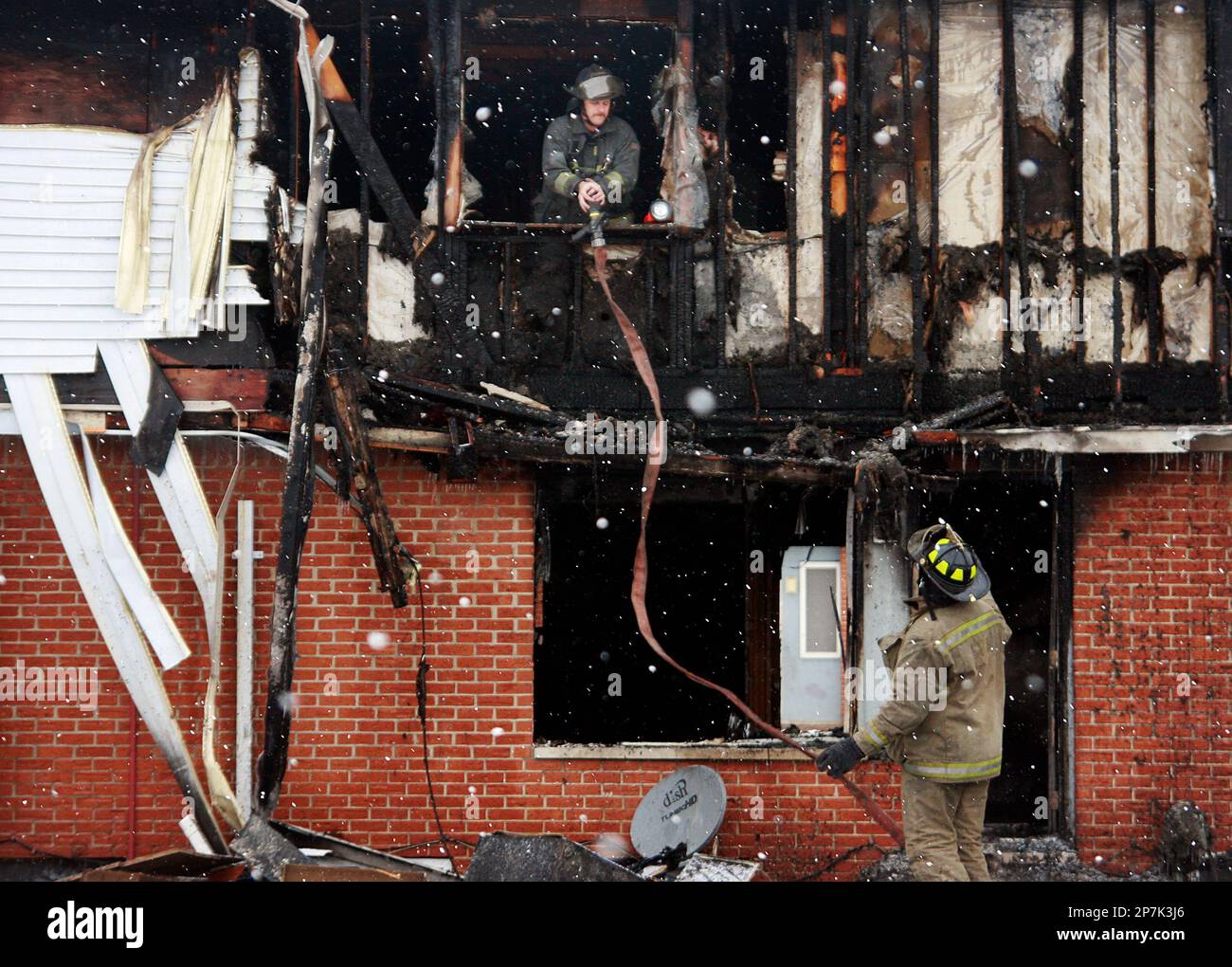 The Flint Fire Department works to put out a flare up at a fire that ...