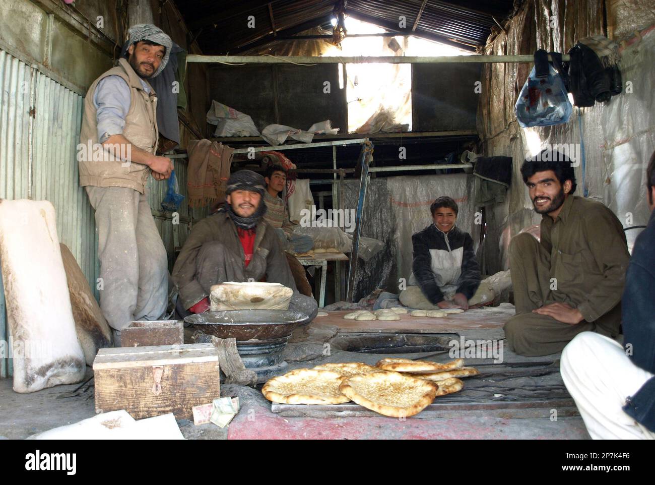 Afghan men smile inside a bakery shop in downtown Kabul, Afghanistan on ...