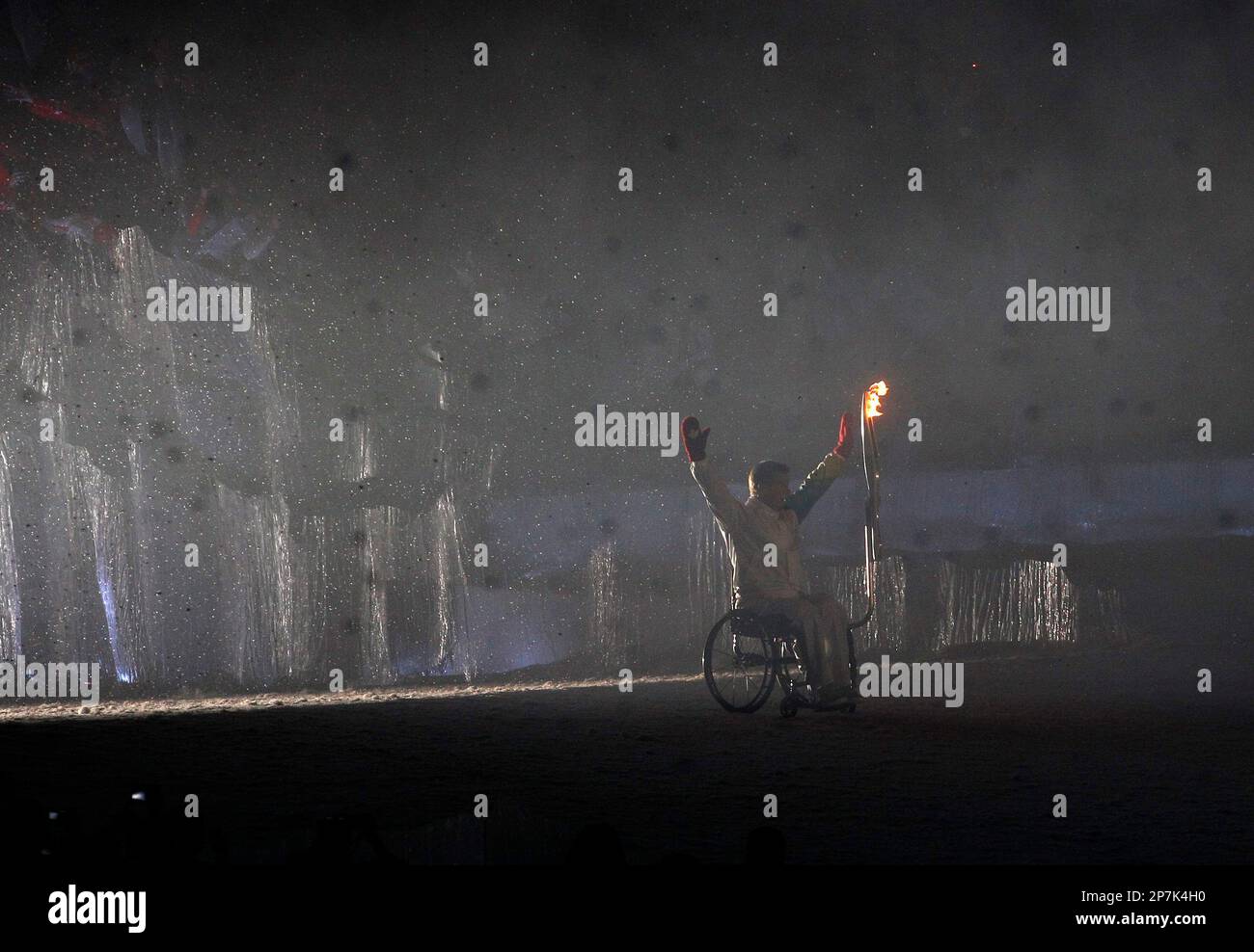 Canadian wheelchair athlete Rick Hansen holds the Olympic torch during ...