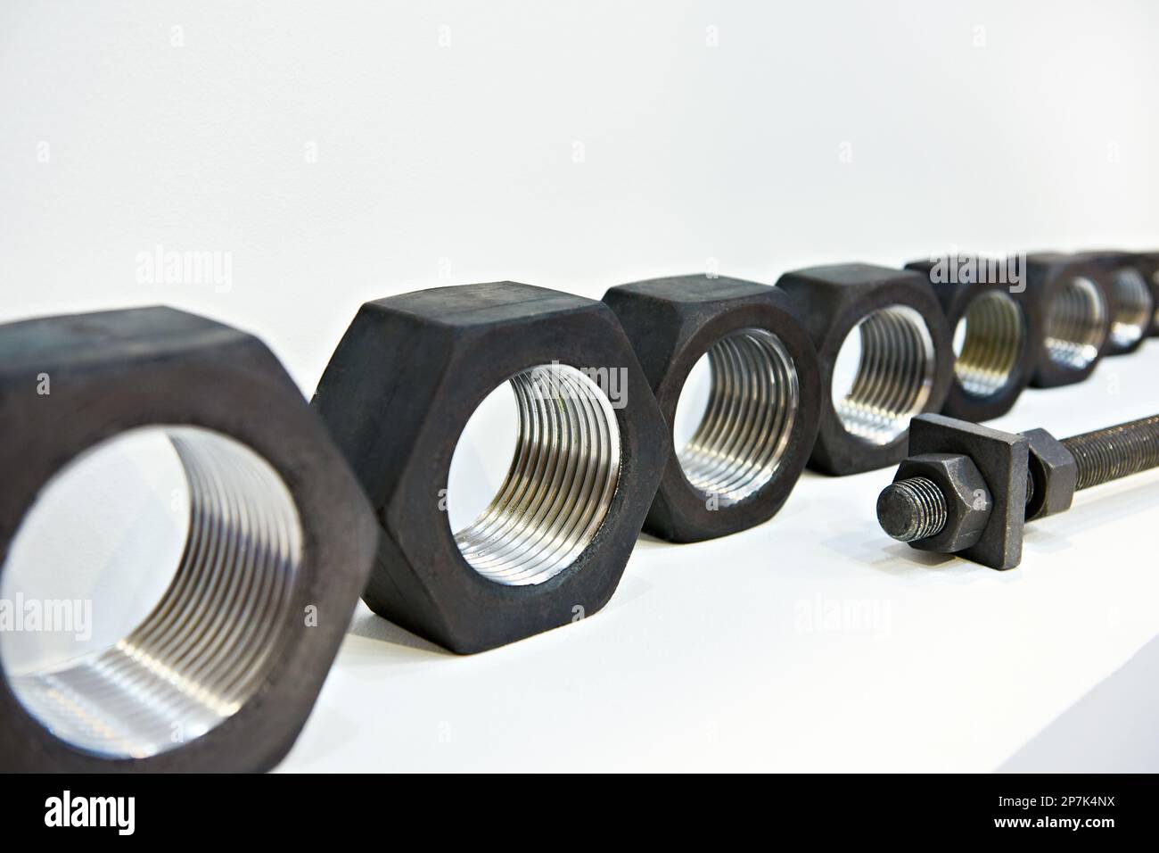 Row of large metal nuts Stock Photo - Alamy