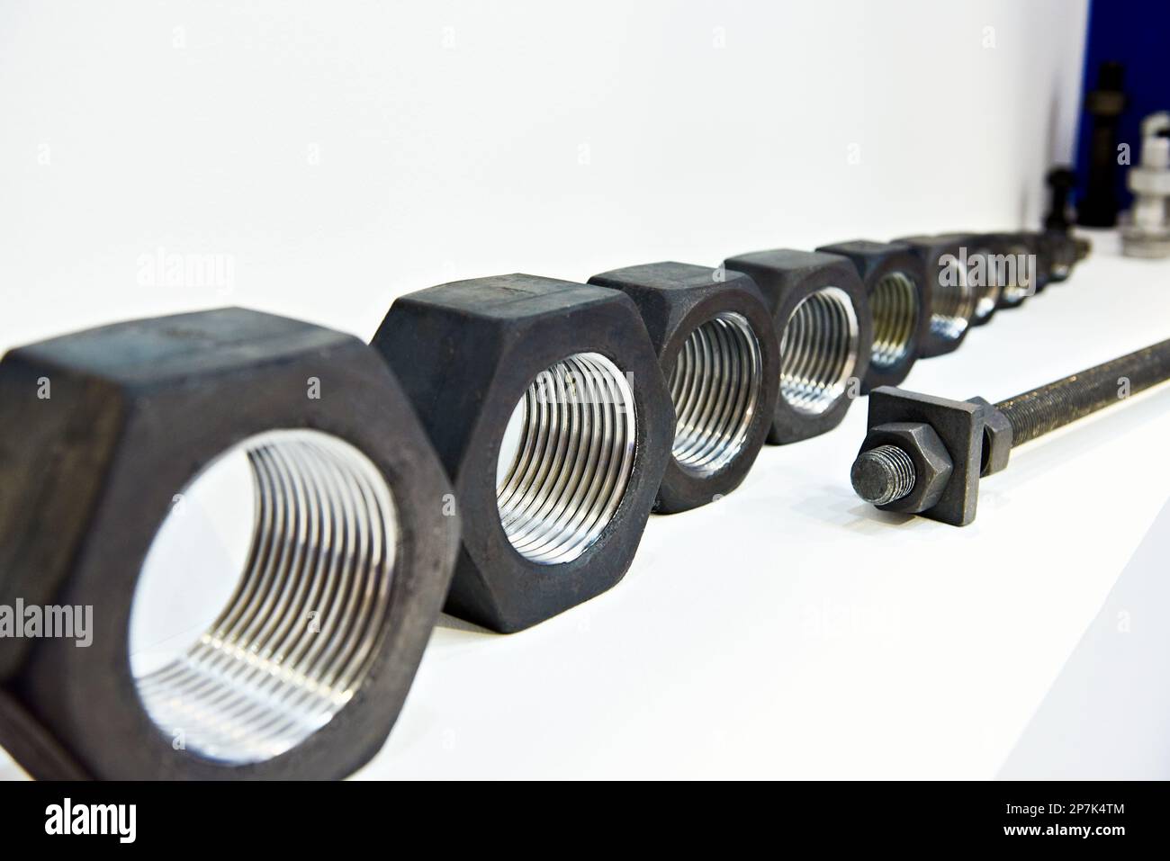 Row of large metal nuts Stock Photo - Alamy